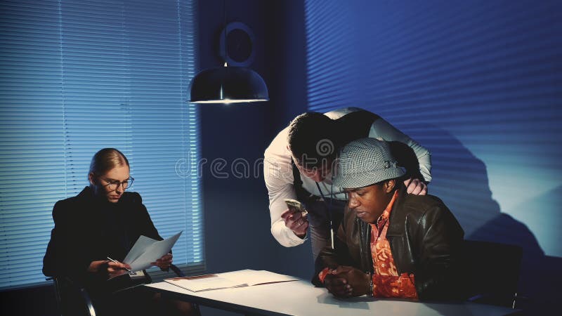 Detective Uses Force in Questioning the Accused Black Man. Stock Photo ...