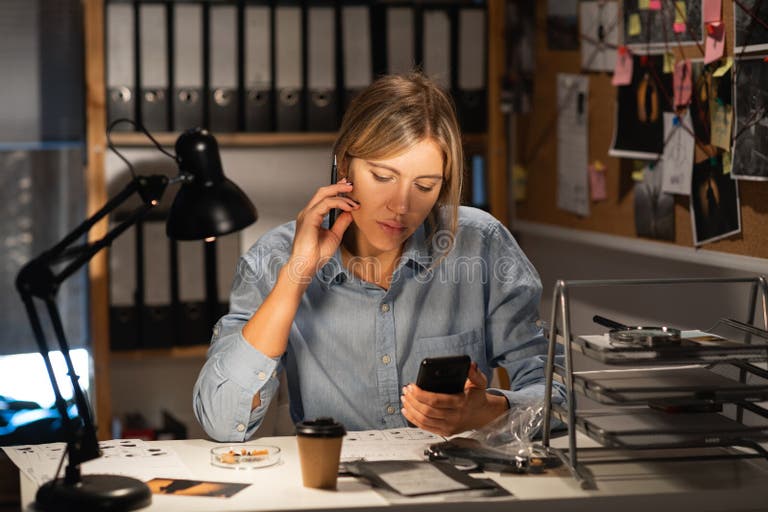 Detective Working at Desk in Her Office Looking at Cellphone. Stock ...
