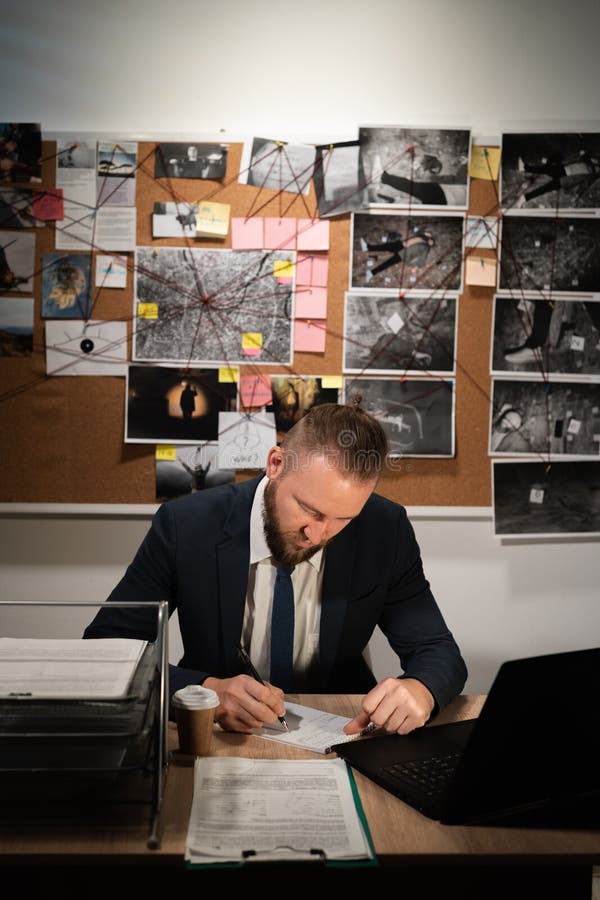 Detective Working at Desk in His Office, Evidence Board on Background ...