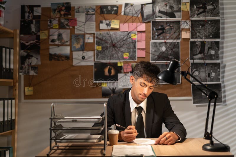 Detective Working at Desk in His Office, Writing Documents Criminal ...