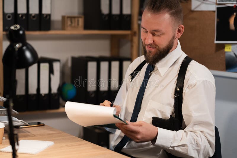 Detective Working with Documents at Desk in His Office Stock Photo ...