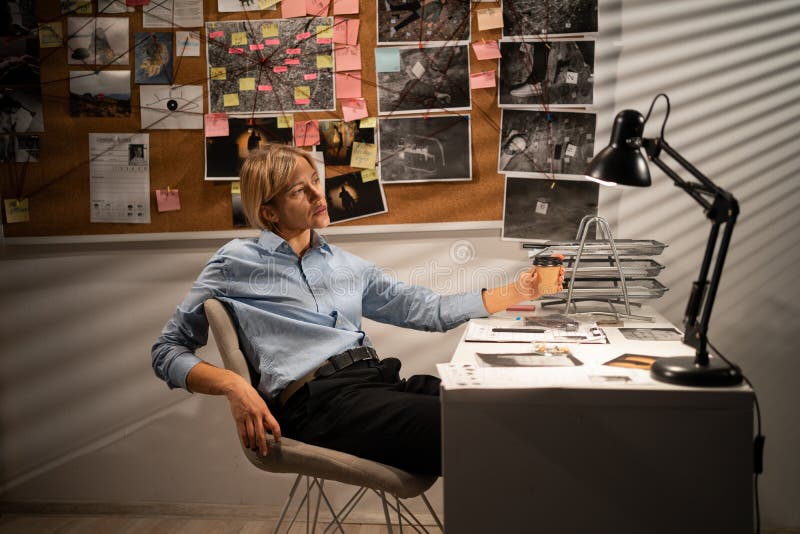 Detective Working in Her Office, Drinking Coffee and Thinking Stock ...