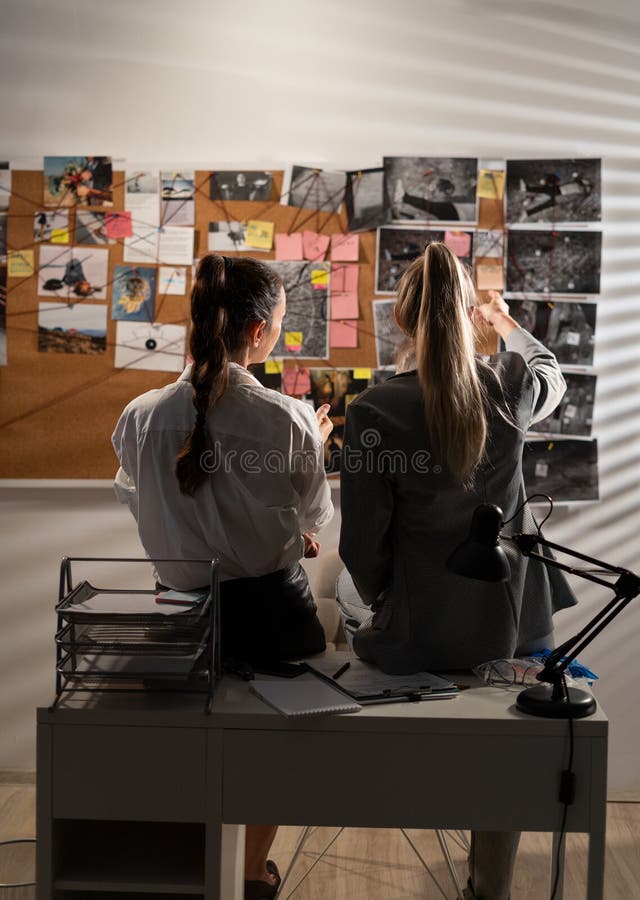 Detectives Looking at Evidence Board in Office, Back View. Stock Image ...