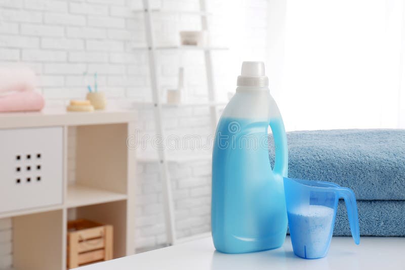 Detergents and Clean Towels on Table, Space for Text. Laundry Day Stock ...