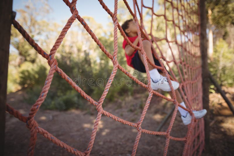 Determined Boy Climbing a Net during Obstacle Course Stock Photo ...
