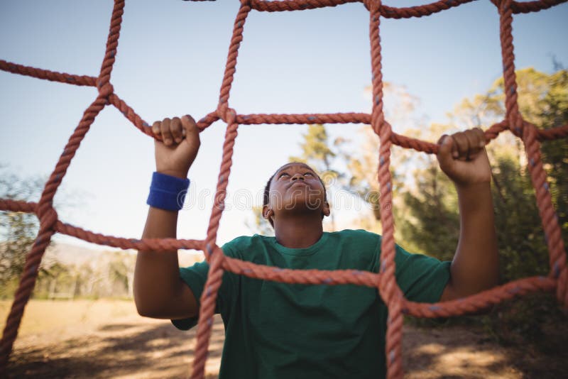 Determined Boy Climbing a Net during Obstacle Course Stock Image ...