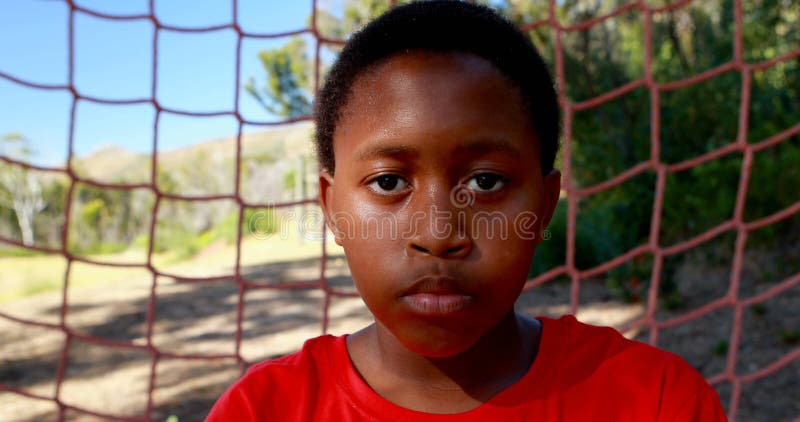 Determined Boy Standing Against Net during Obstacle Course in Boot Camp ...