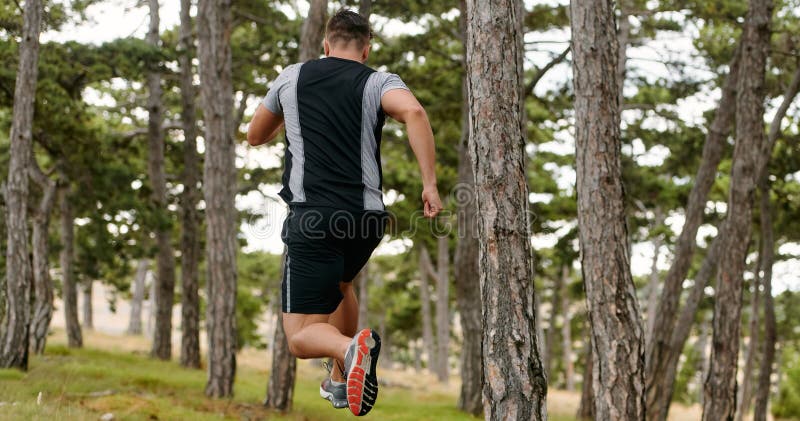 Determined Man Conquering Forest Obstacles with Grit and Speed Stock ...