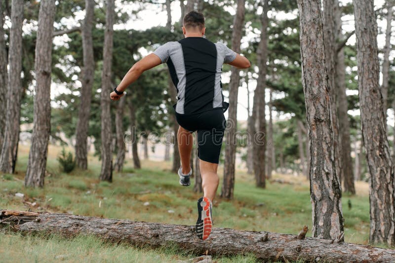 Determined Man Conquering Forest Obstacles with Grit and Speed Stock ...