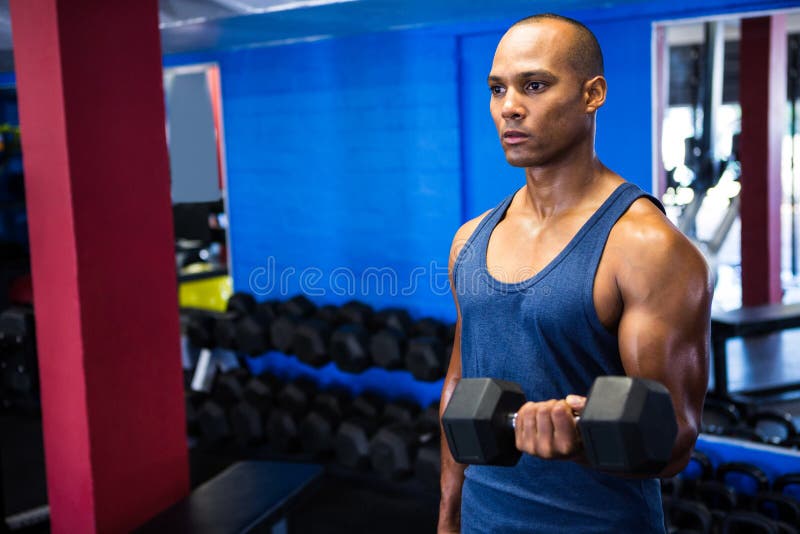 Determined Man Exercising with Dumbbells Stock Photo - Image of ...