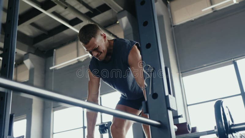 Determined Man Lifting Weights in Modern Gym for Strength Training ...