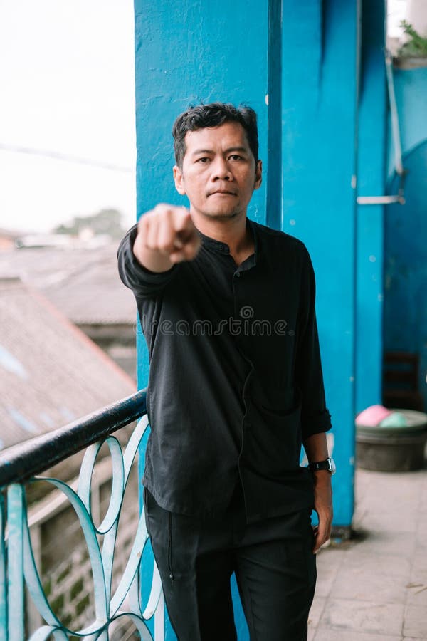 Determined Man Points Finger at Viewer with Serious Expression Stock ...
