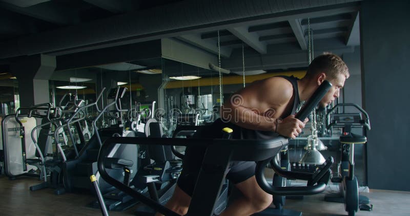 Determined Man Training Intensely on a Gym Rowing Machine Stock Footage ...