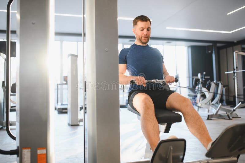 Man Doing Rehabilitation Exercises with Cable Row Machine in Gym Stock ...