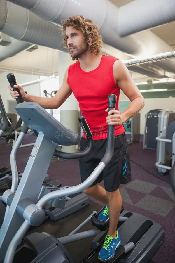 Determined Man Working Out on X-trainer in Gym Stock Photo - Image of ...