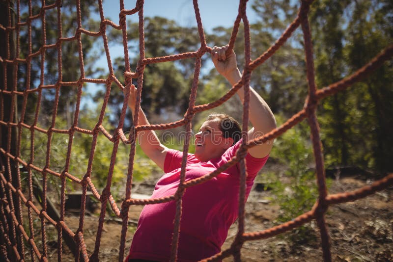 Determined Woman Climbing a Net during Obstacle Course Stock Image ...