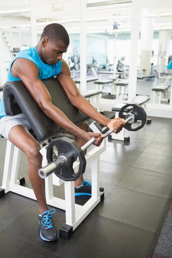 Determined Young Man Lifting Barbell in Gym Stock Photo - Image of ...