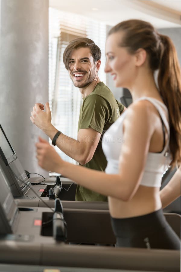 Determined Young Man Smiling while Running on Treadmill during H Stock ...