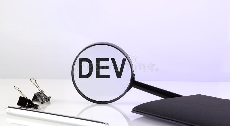 DEV Concept. Magnifier Glass with Text with Notebook and Pen Stock ...