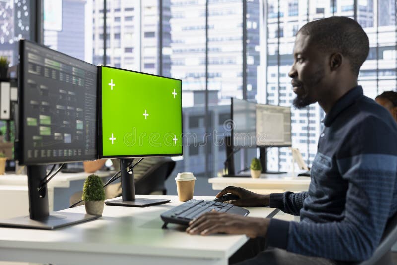 Developer Conducting Experiments And Tests On Green Screen Computer