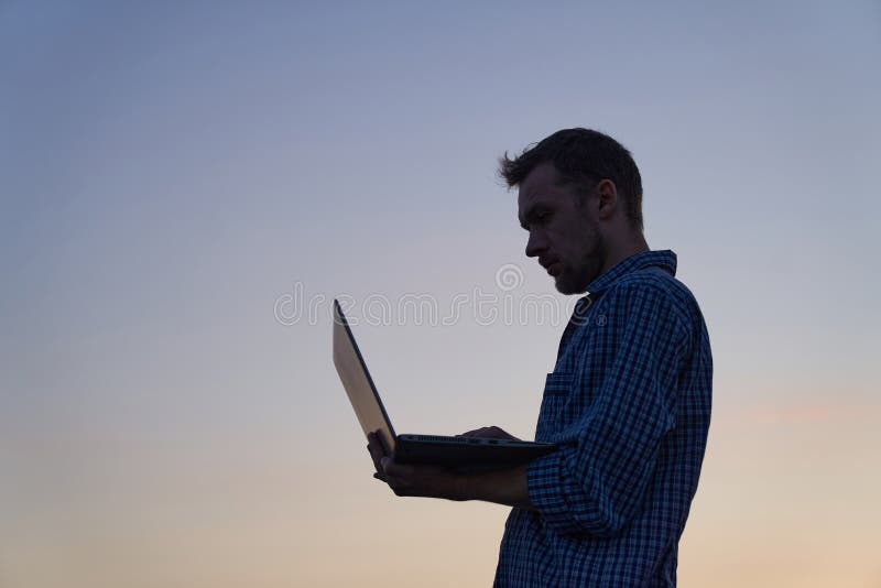 Developer Male in Silhouette Using Laptop Outdoor at Sunset, Working ...