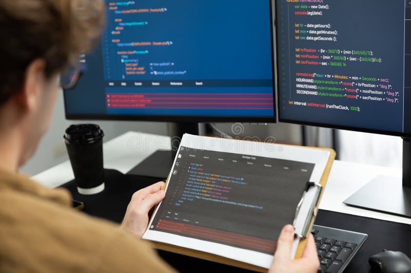 It Developer Reading Coding on Document Paper Software with Screens ... It Developer Reading Coding on Document Paper Software with Screens ...
