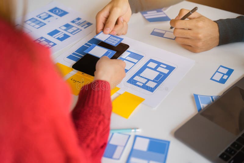 Developer Team Brainstorming on Their Project with Laptop, Smartphone ...