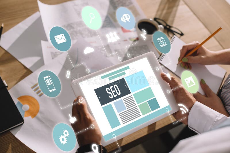 Developers Using Digital Tablet with SEO Symbols Stock Photo - Image of ...
