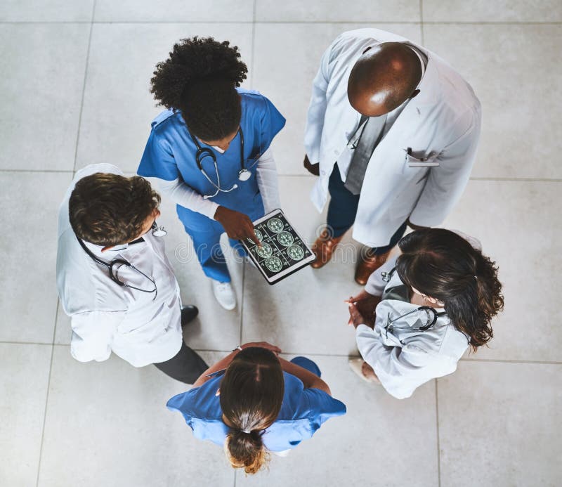 Developing a Life Saving Strategy. High Angle Shot of a Team of Doctors ...