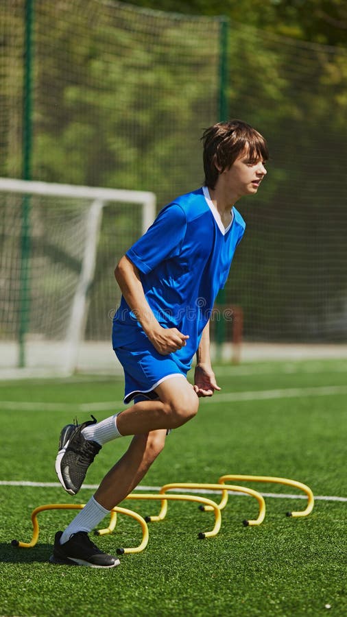 Developing Soccer Skills. Young Soccer Player in Blue Uniform Training ...