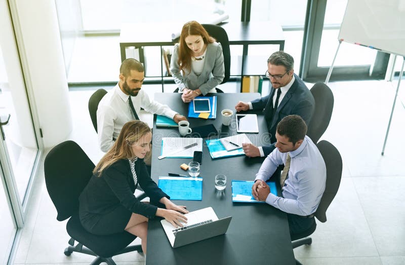 Developing a Solid Action Plan As a Team. a Team of Executives Having a ...