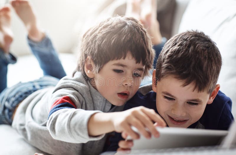 Developing Their Digital Tech Savviness. Two Adorable Brothers Using a ...