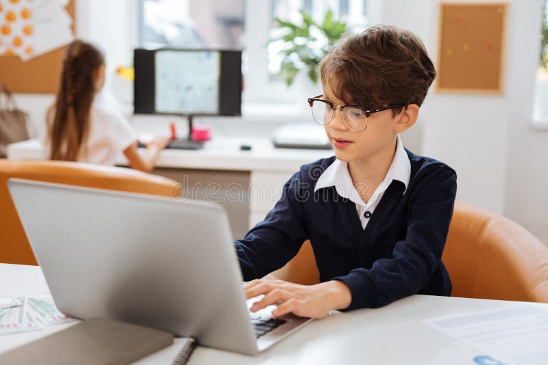 Smart Boy Using a Laptop in a Classroom Stock Photo - Image of emotions ...