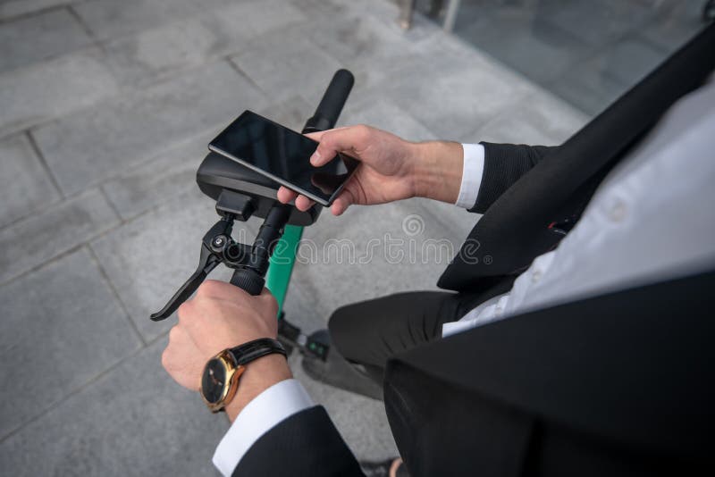 Close Up Picture of Mans Hands Holding a Handle Bar and Smartphone ...
