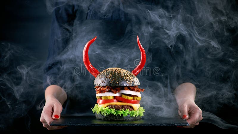Devil Burger with Bacon and Vegetables on Black Slat Plate Stock Image ...