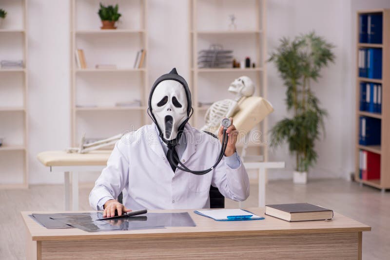 Devil Doctor Examining Skeleton Patient Stock Photo - Image of witch ...