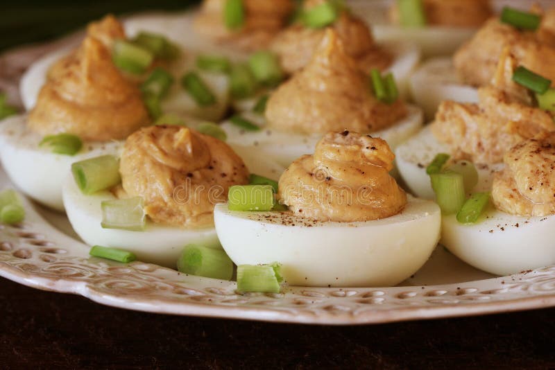 Deviled Eggs with Cod Livers with Leek on White Plate. Rustic Wooden Table Stock Image - Image ...