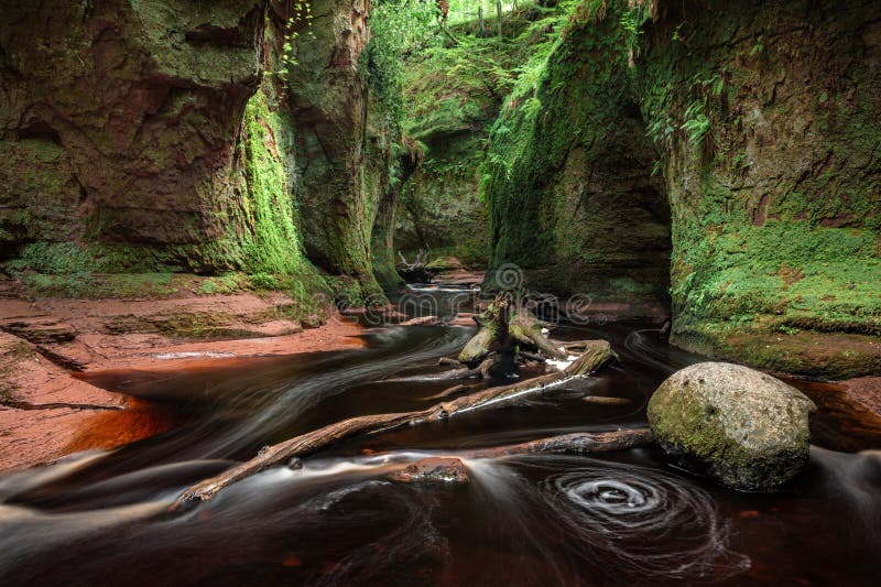 Devils Pulpit Gorge, Scotland, with Dark Red River Flowing through ...
