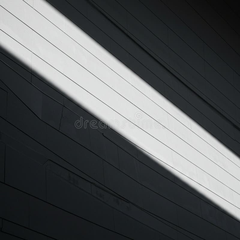 Diagonal Light Beam Casts a Dramatic Contrast on a Tile-covered Wall ...