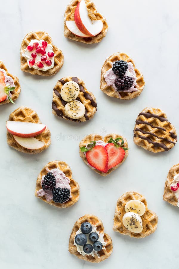 Diagonal Rows of Mini Heart Shaped Waffles with Various Toppings. Stock ...