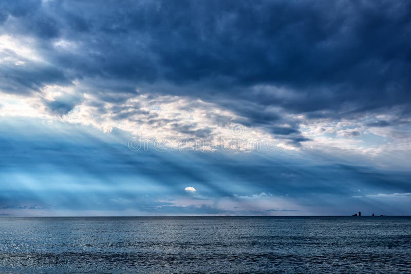 Diagonal Sun Rays Under Dark Clouds Stock Image - Image of overcast ...