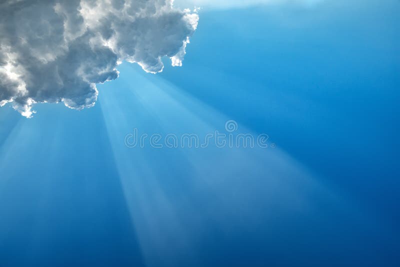Diagonal Sunbeam on a Blue Sky Under a Cloud Stock Image - Image of ...
