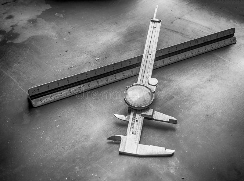 Dial Caliper and Ruler on a Machine Shop Steel Bench Stock Photo ...