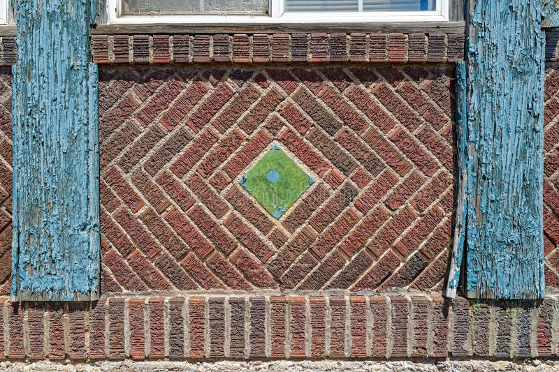 A Diamond Shaped Tile Inlay on the Exterior Brick Wall of an Old ...
