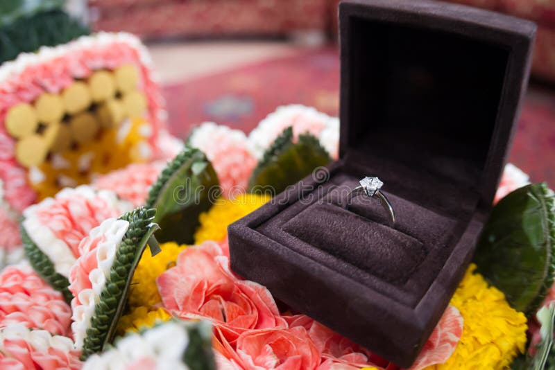 A Diamond Wedding Ring in an Open Box on Traditional Thai Style Stock ...
