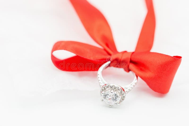 Diamond Wedding Rings in the Red Ribbon on White. Selective Focus Stock ...