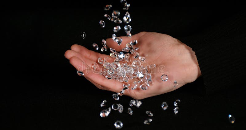 Diamonds Falling into Hand Against Black Background Stock Photo - Image ...