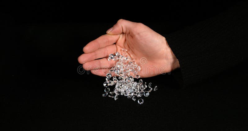 Diamonds Falling into Hand Against Black Background Stock Photo - Image ...
