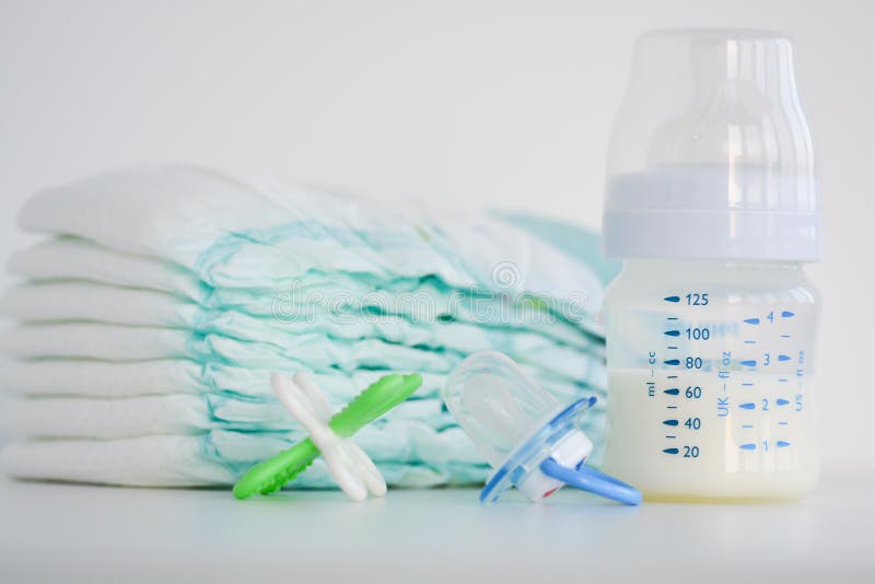 Diapers, Milk Bottle and a Pacifier Stock Photo - Image of parenting ...