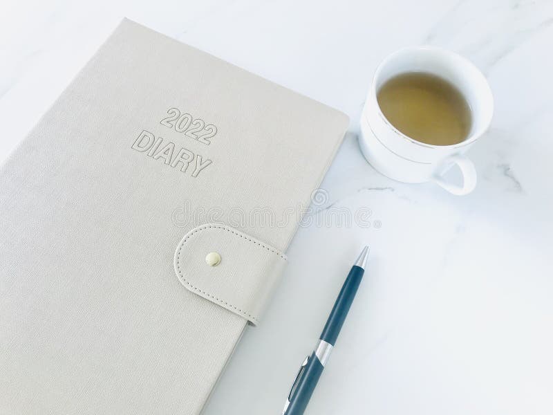 2022 Diary with a Cup of Tea and a Pen on White Marble Background ...